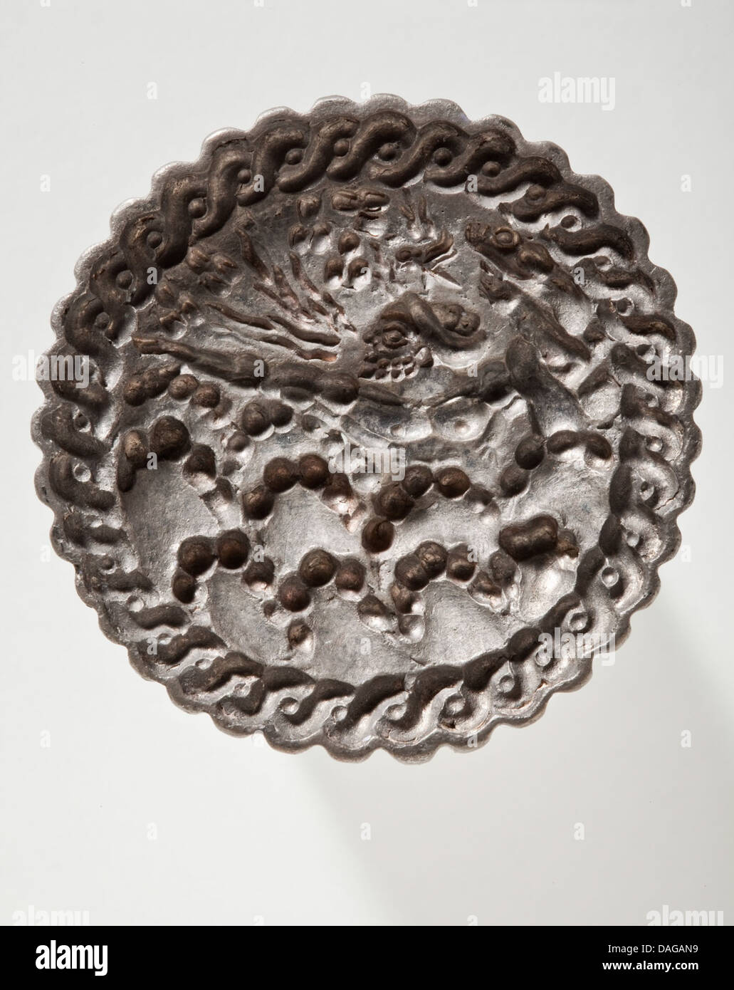 This stamp seal depicts a man, two snakes, and a bird, intricately ...