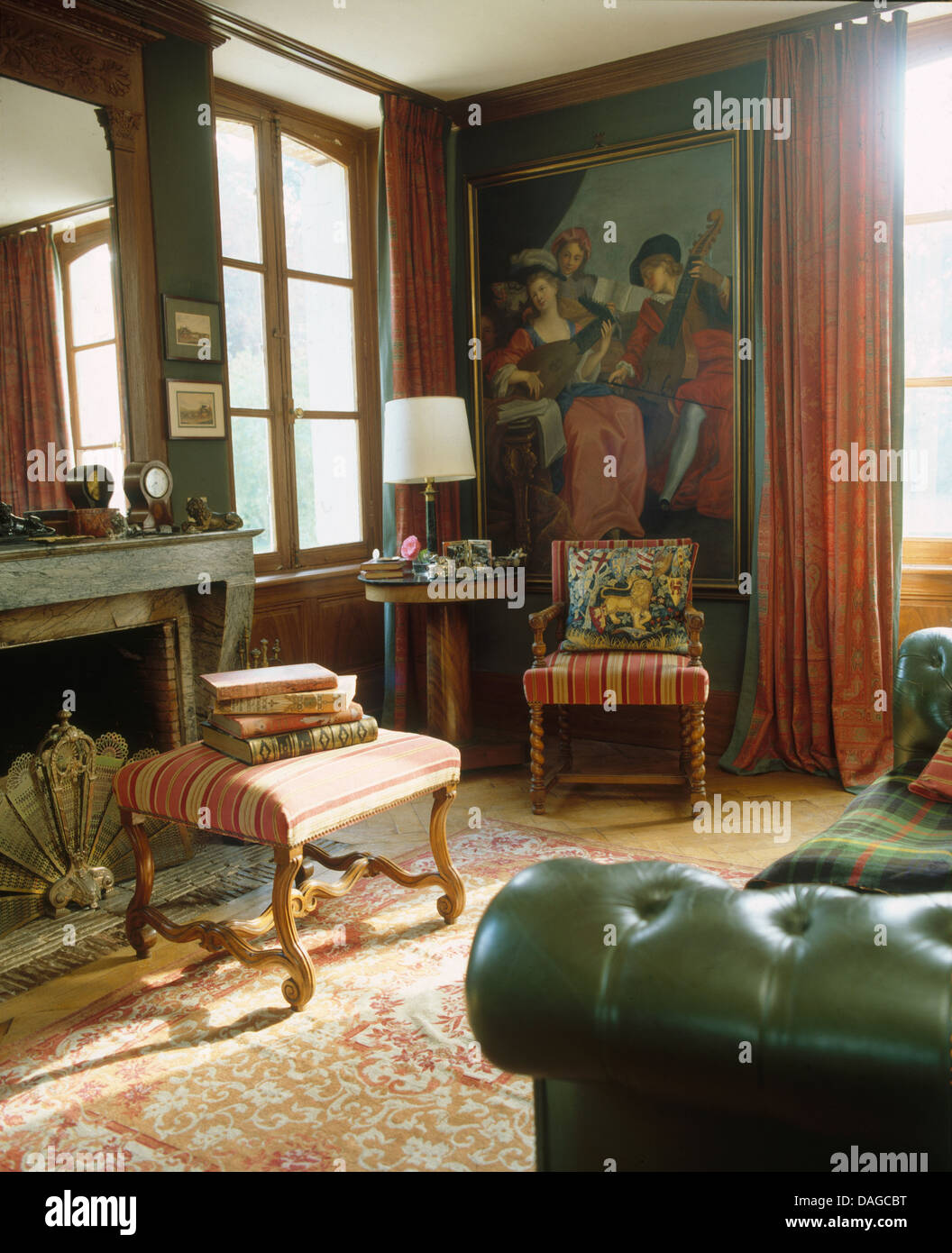 Large painting in corner of French drawing room with upholstered stool ...
