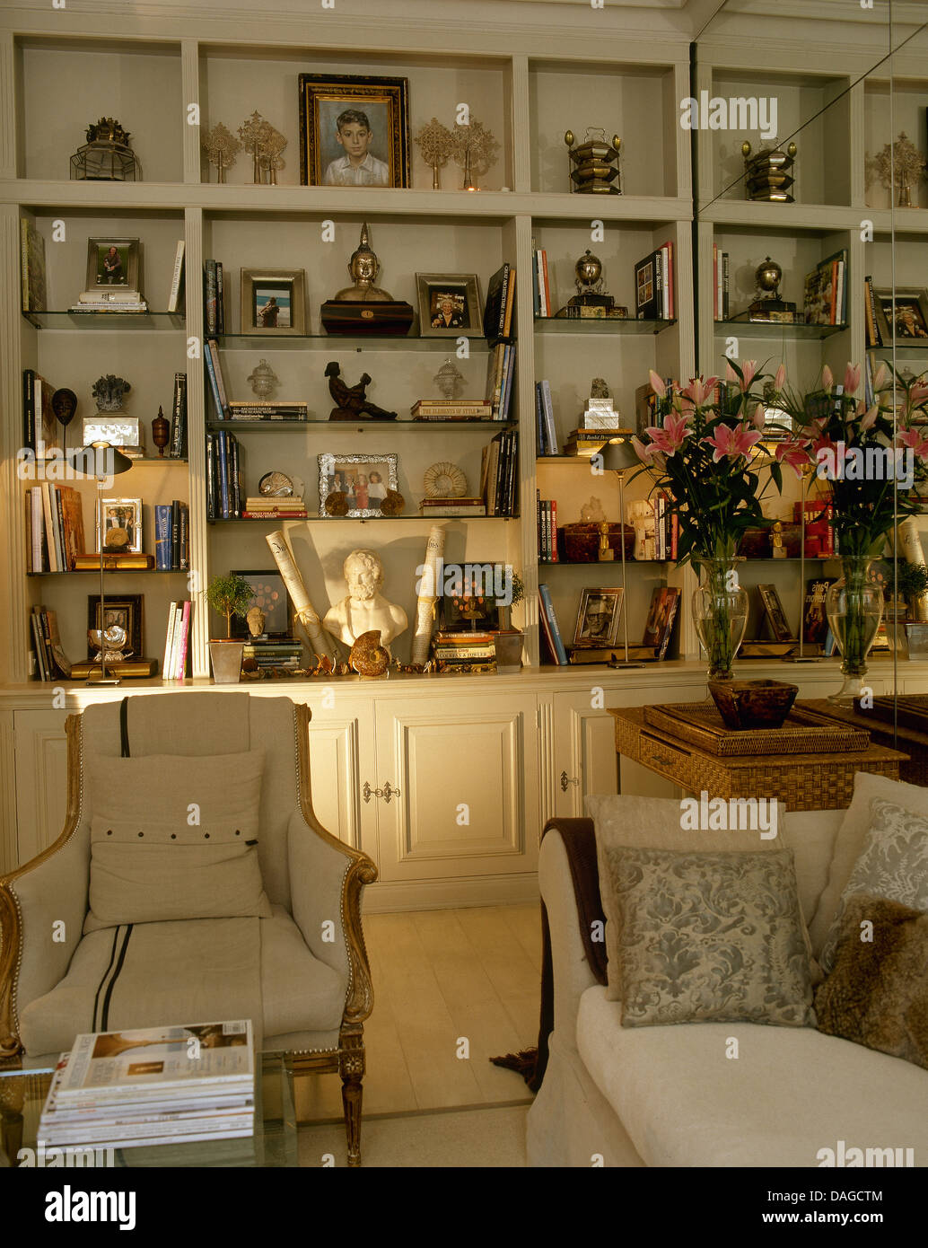 Collection of artefacts on built in shelving in town house living room ...