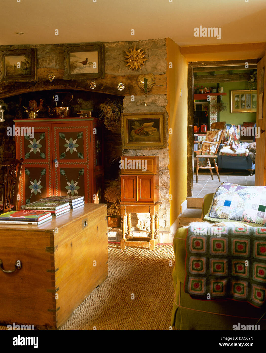 Large antique pine chest and painted cupboard in cluttered cottage ...