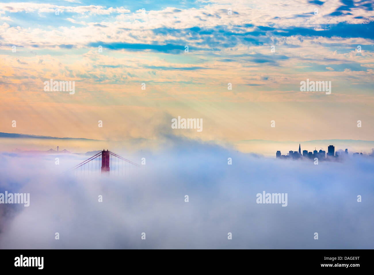 Golden Gate Bridge surrounded by Fog during Sunrise Stock Photo - Alamy