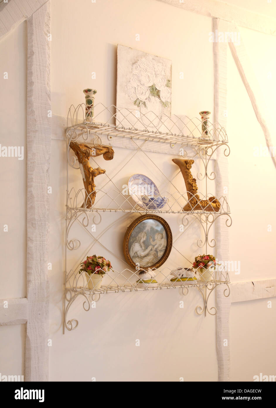 Close-up of collection of objects displayed on wall mounted white wire ...