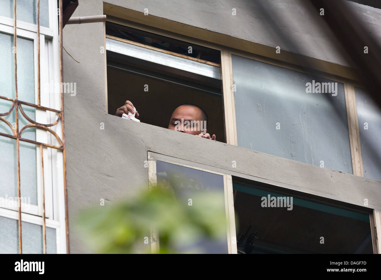 Man in a Window in Hanoi, Vietnam Stock Photo - Alamy