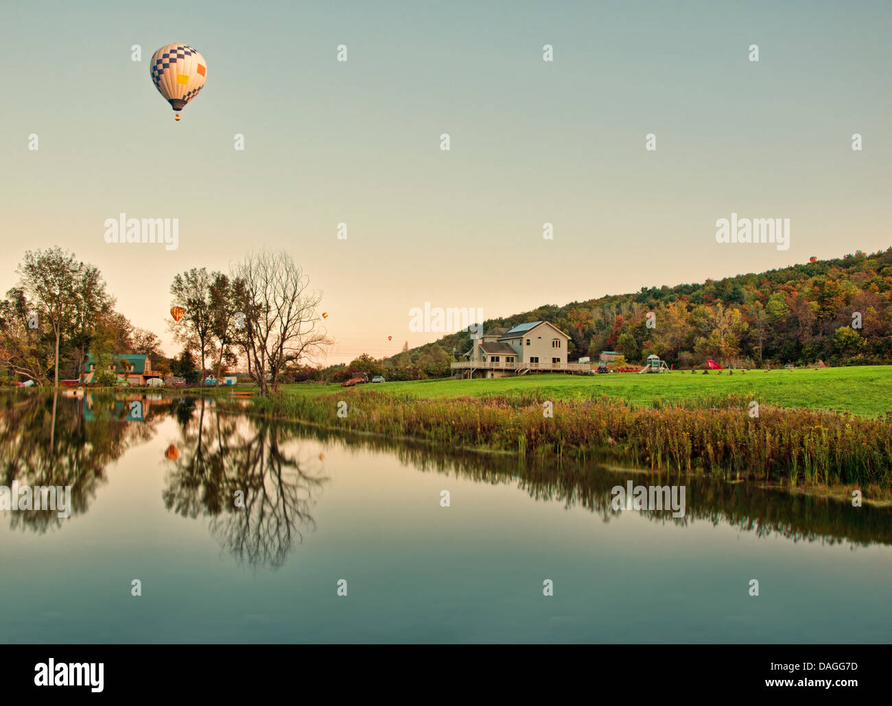 hot air balloons flying over rural landscape Stock Photo - Alamy