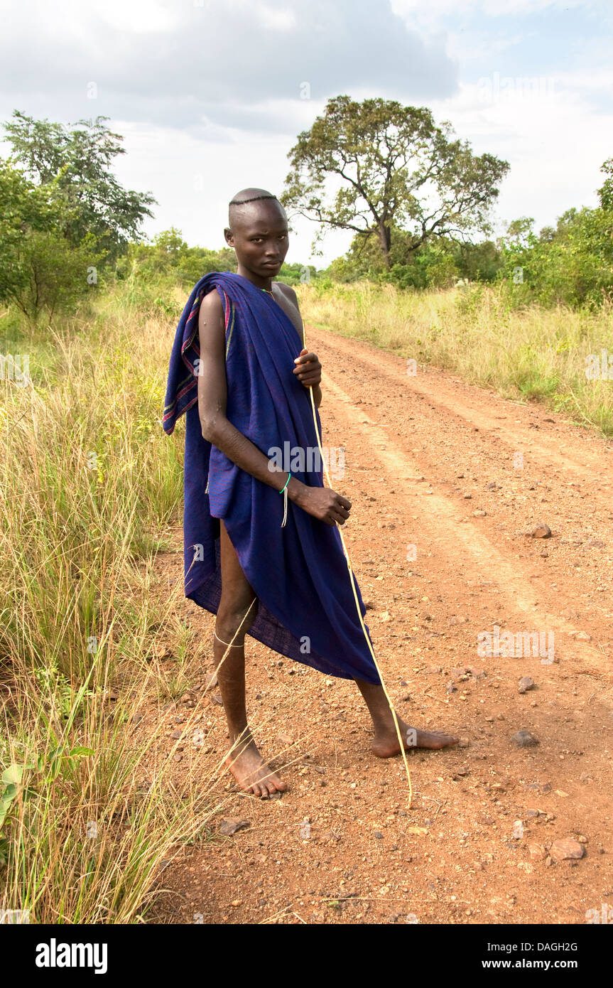 A Suri (Surma) shepherd on a track in the bush, Ethiopia Stock Photo ...