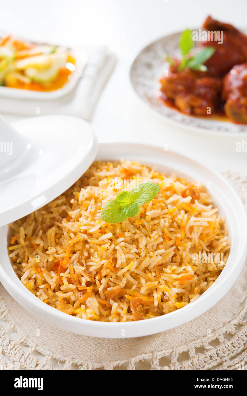 Biryani rice or briyani rice, curry chicken and salad, traditional ...