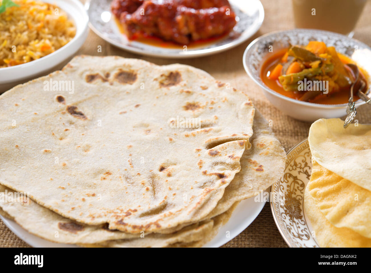 Chapatti roti or chapati, curry chicken, biryani rice, salad, masala ...