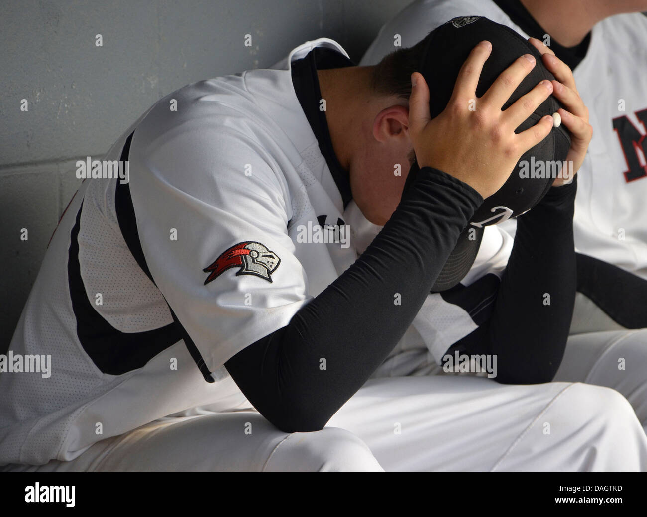player holds his head in disappointment after watching his team play in ...
