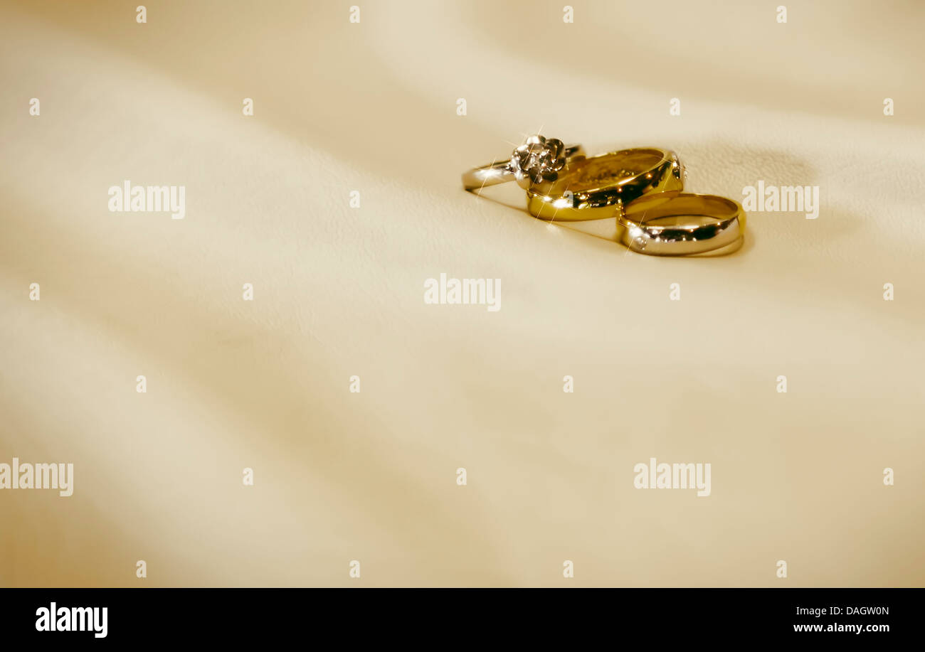 Gold wedding rings with engagement ring inside box Stock Photo - Alamy
