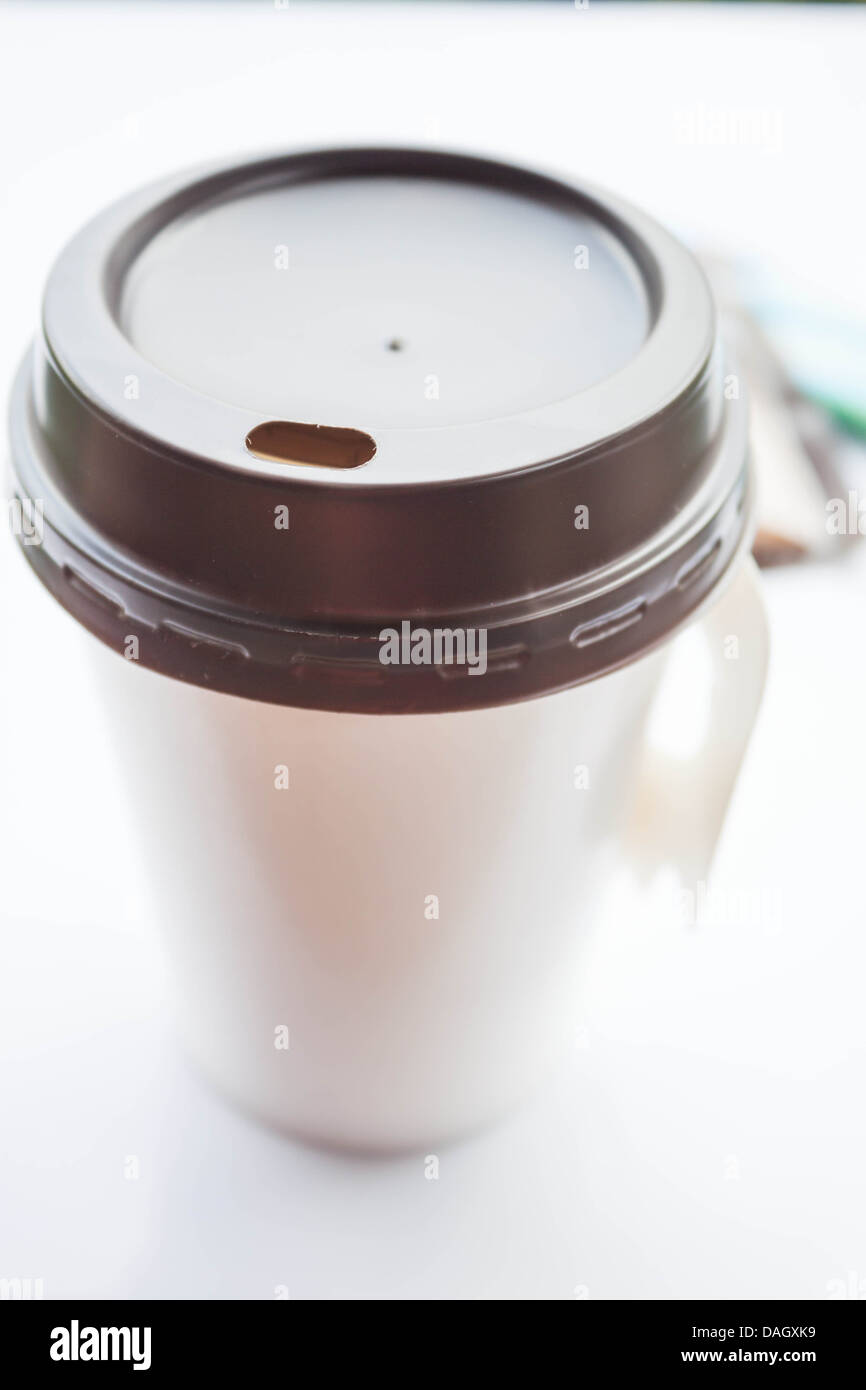 Coffee in paper cup with sugar packs on white background Stock Photo ...