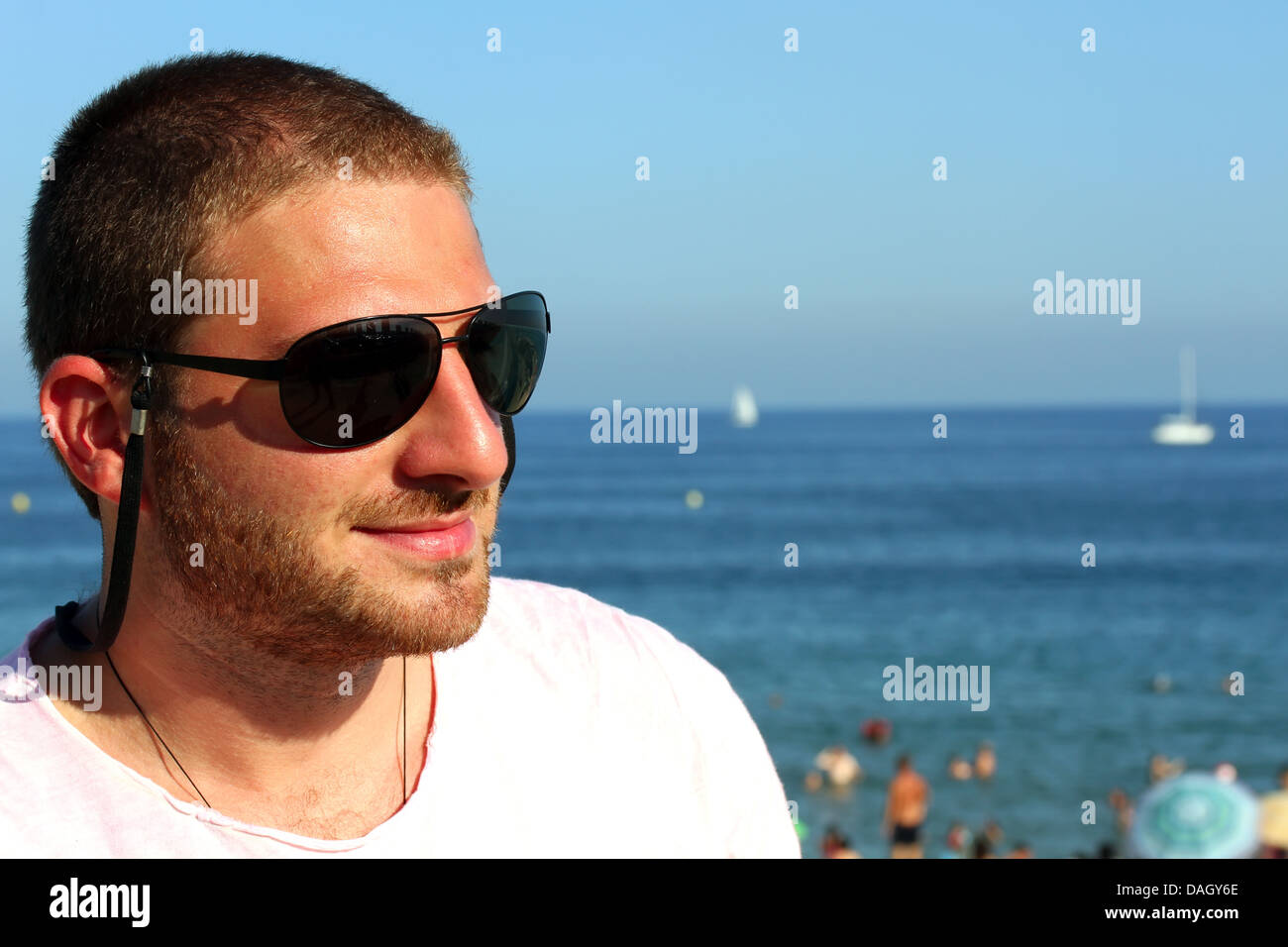 Attractive young man at the beach Stock Photo - Alamy