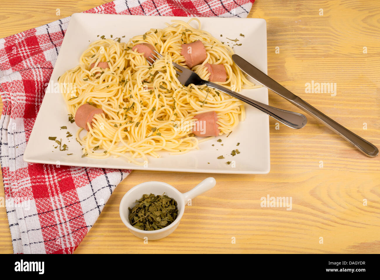 Spaghetti piercing pieces of sausage, a kid meal Stock Photo - Alamy