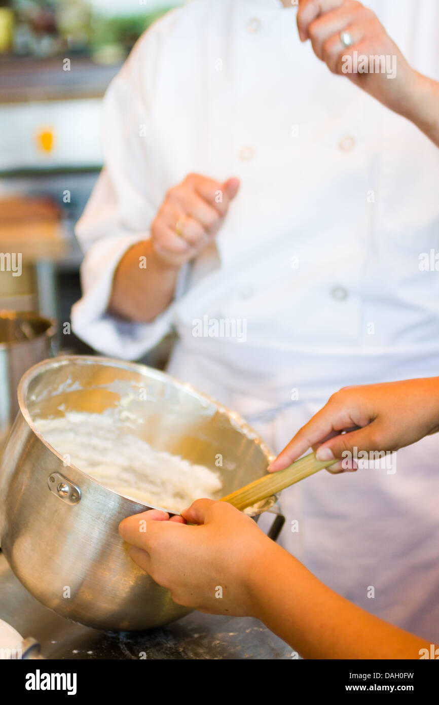 Kinds in cooking class learning how to cook and bake Stock Photo - Alamy