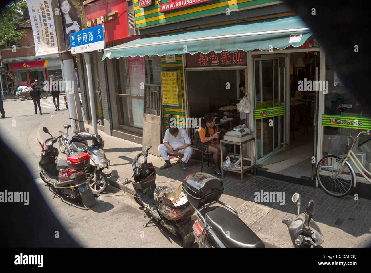 Shanghai city shop owners or workers sitting on the pavement Stock ...