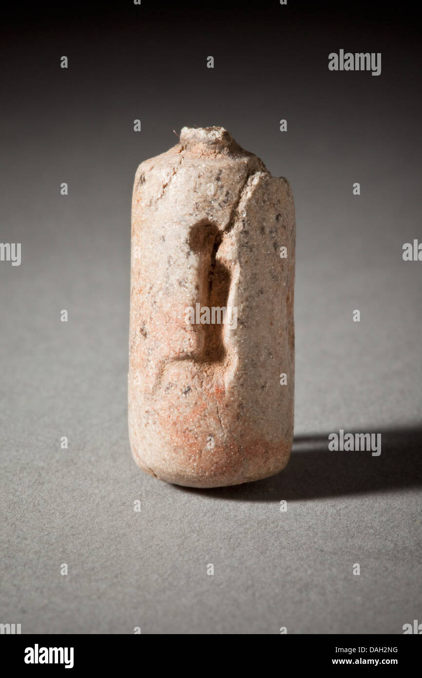 This amulet seal, made of stone, is intricately carved and used as a ...