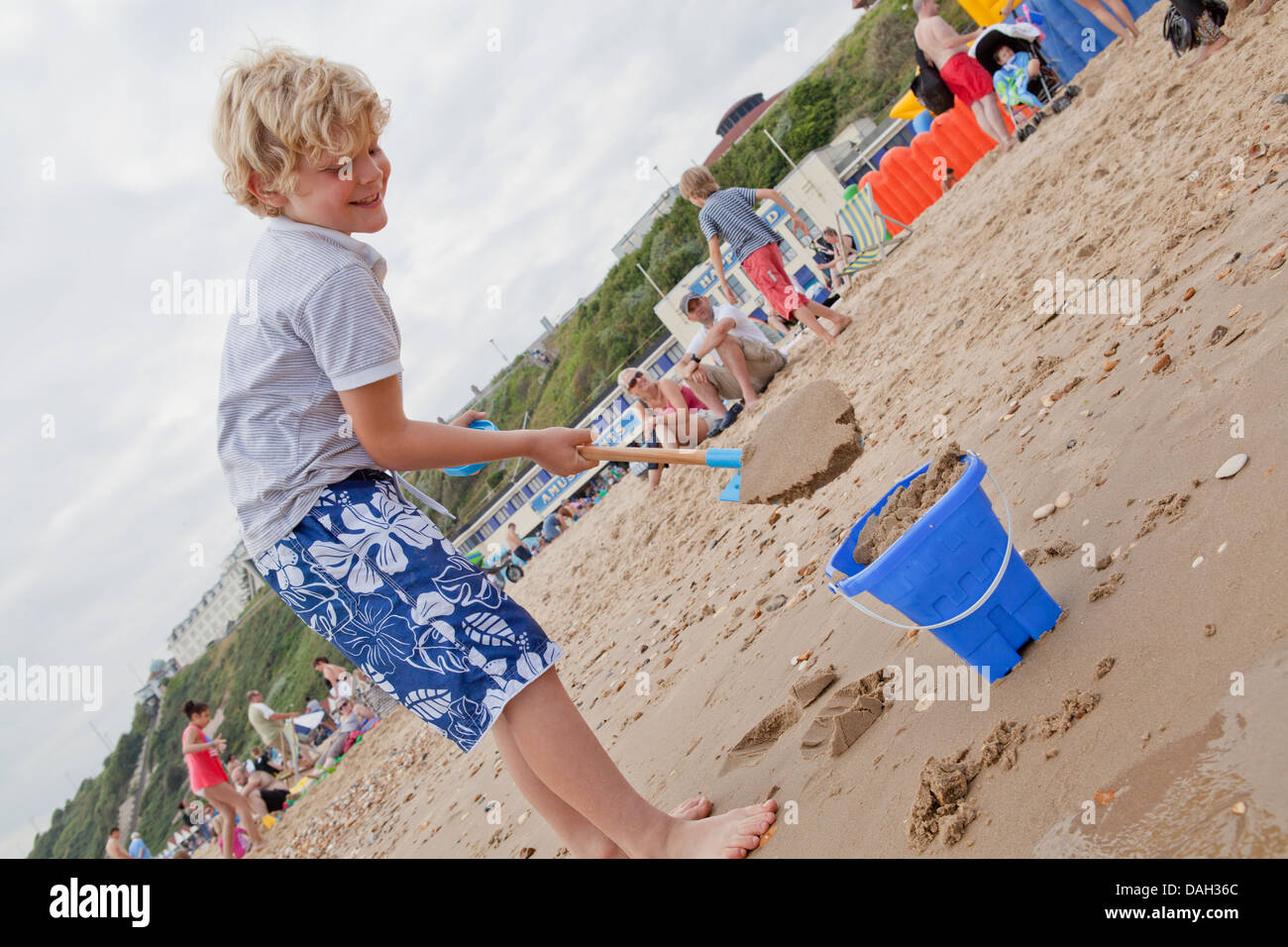 Boy making a sand castle on Bournemouth beach Stock Photo - Alamy