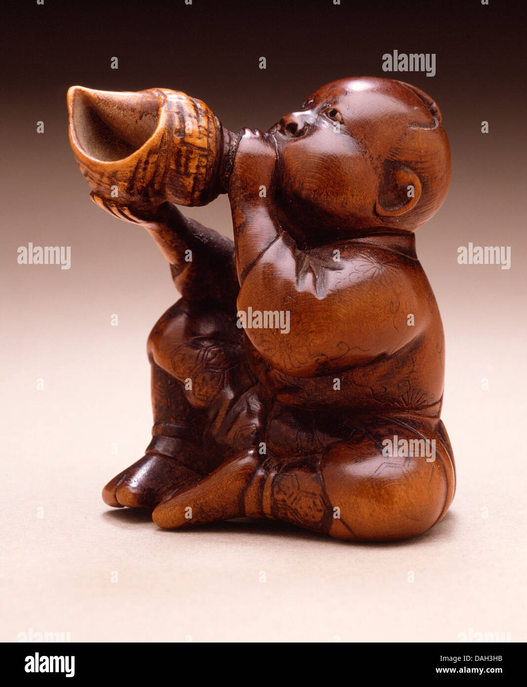 This sculpture depicts a boy blowing a conch shell, representing a ...