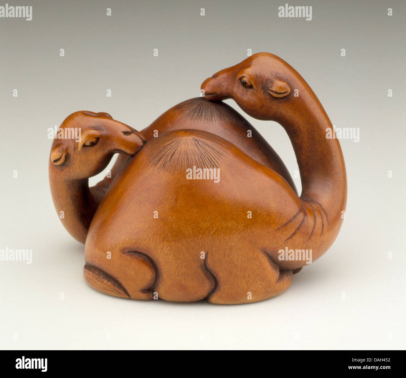 This bronze cast sculpture depicts a pair of camels, showcasing the ...