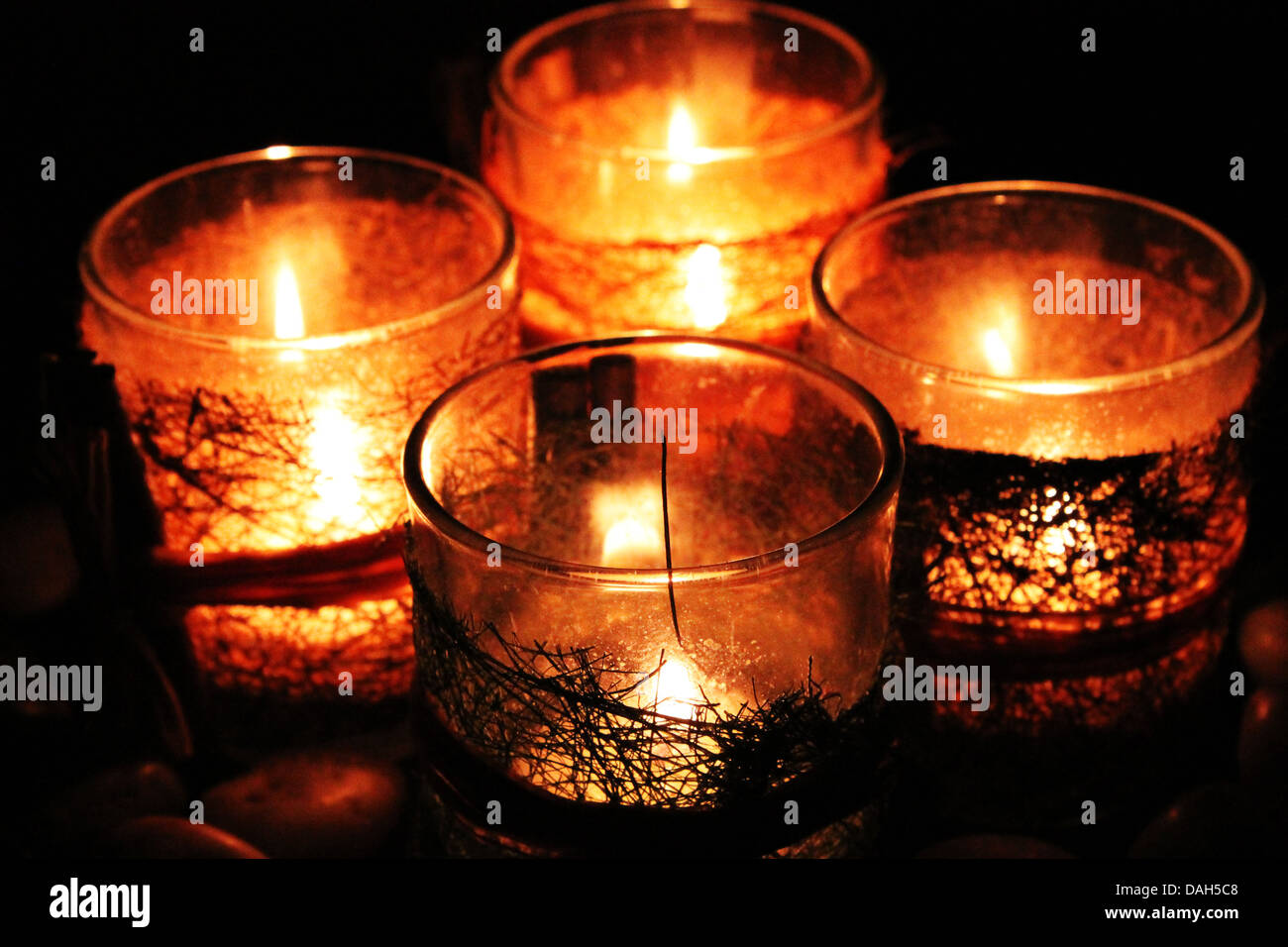 four lighted candles Stock Photo - Alamy