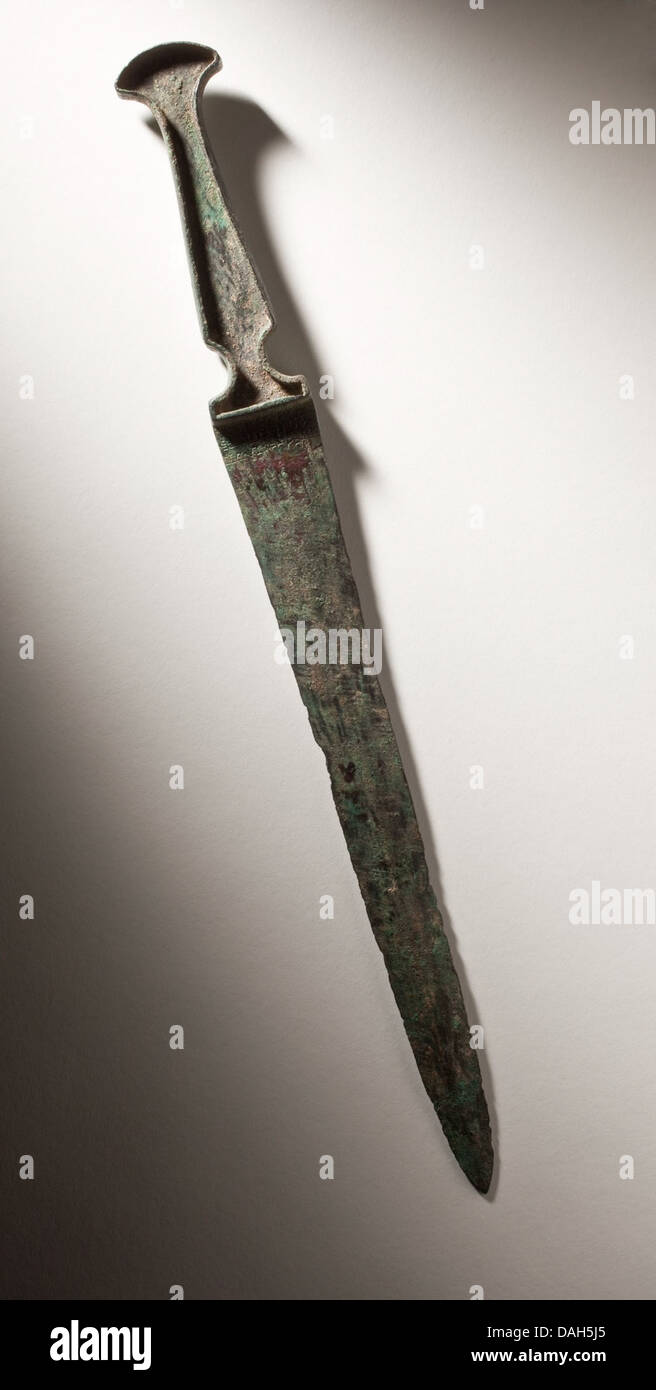 This dagger, crafted from bronze, features a finely cast blade and ...