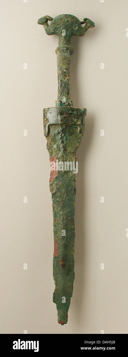 This ancient dagger, crafted from bronze, features intricate details ...