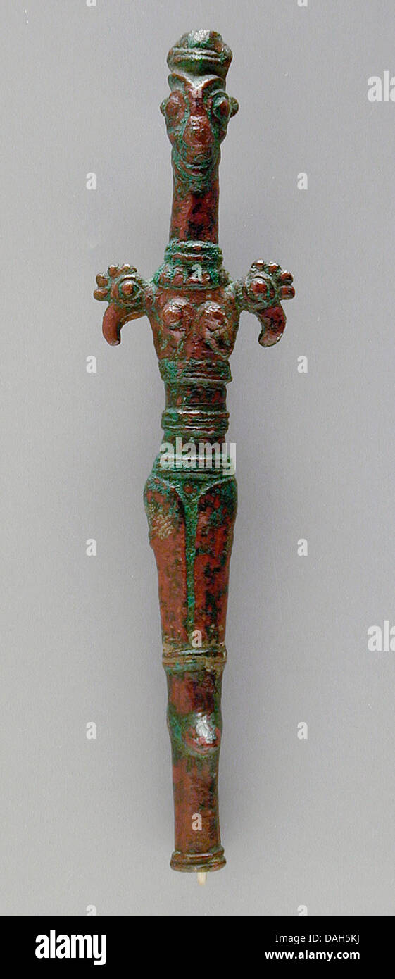 A decorated tube, likely an artifact used in ancient cultural practices ...