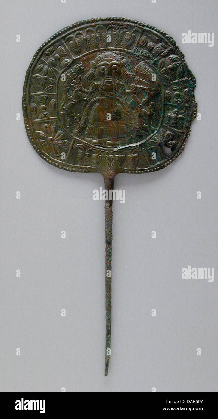 A bronze disc-headed pin, showcasing ancient decorative metalwork. This ...