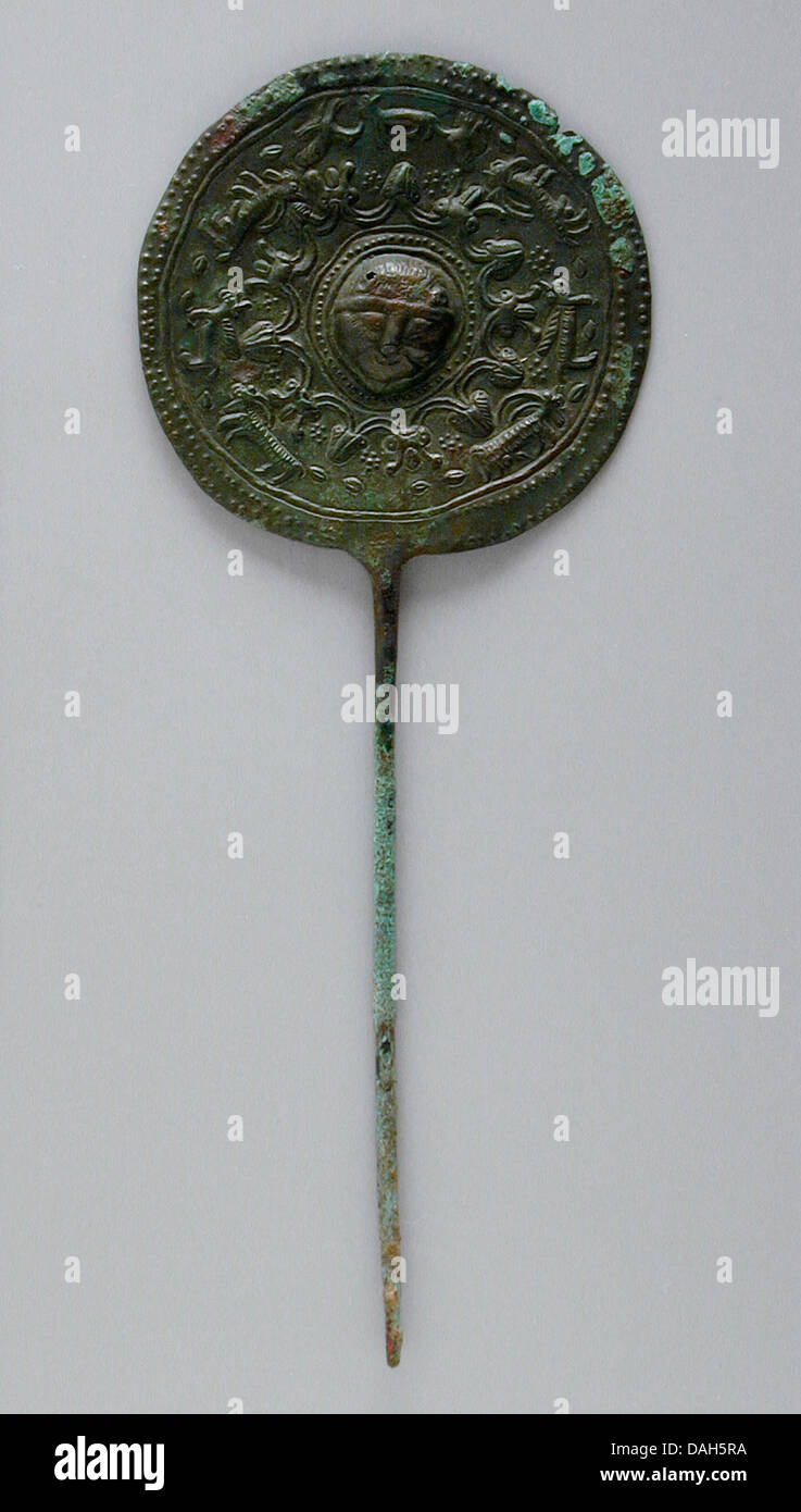 This disc-headed pin is an example of ancient adornment, showcasing the ...