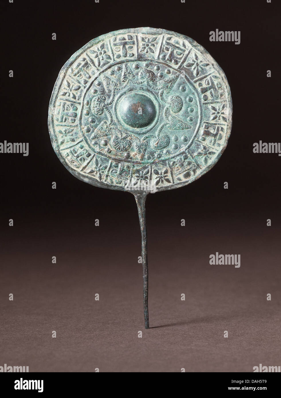 This disc-headed pin, made of bronze, is an example of decorative art ...