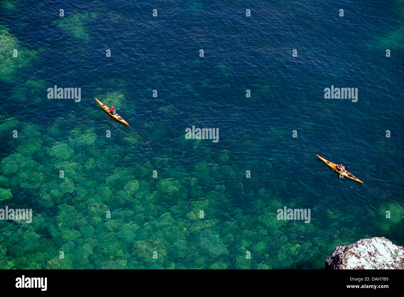 Cornwall, UK. 13th July 2013. Two canoeists enjoying the calm clear ...