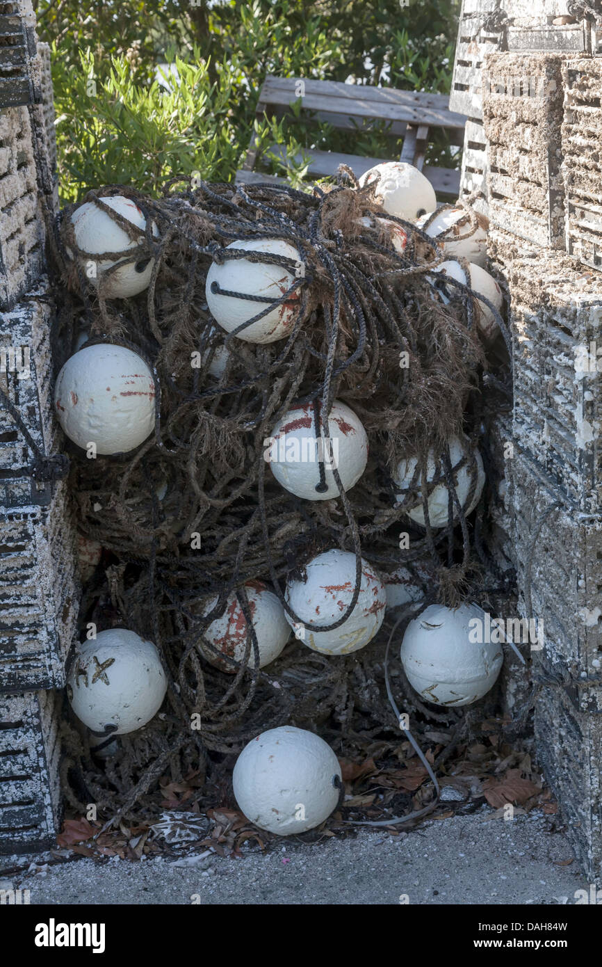 Commercial seafood shellfish traps and floats stacked by the roadside ...