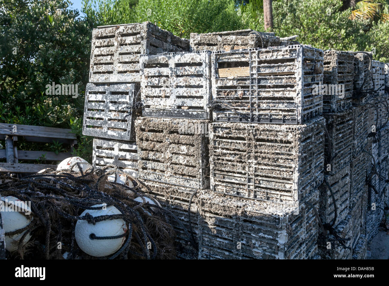 Commercial seafood shellfish traps and floats stacked by the roadside ...