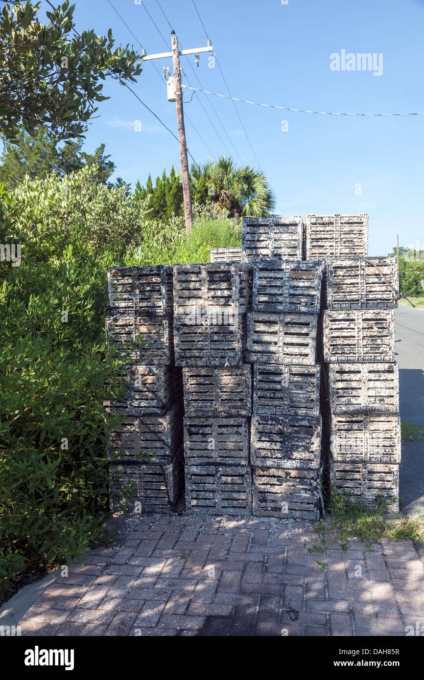 Commercial seafood shellfish traps and floats stacked by the roadside ...