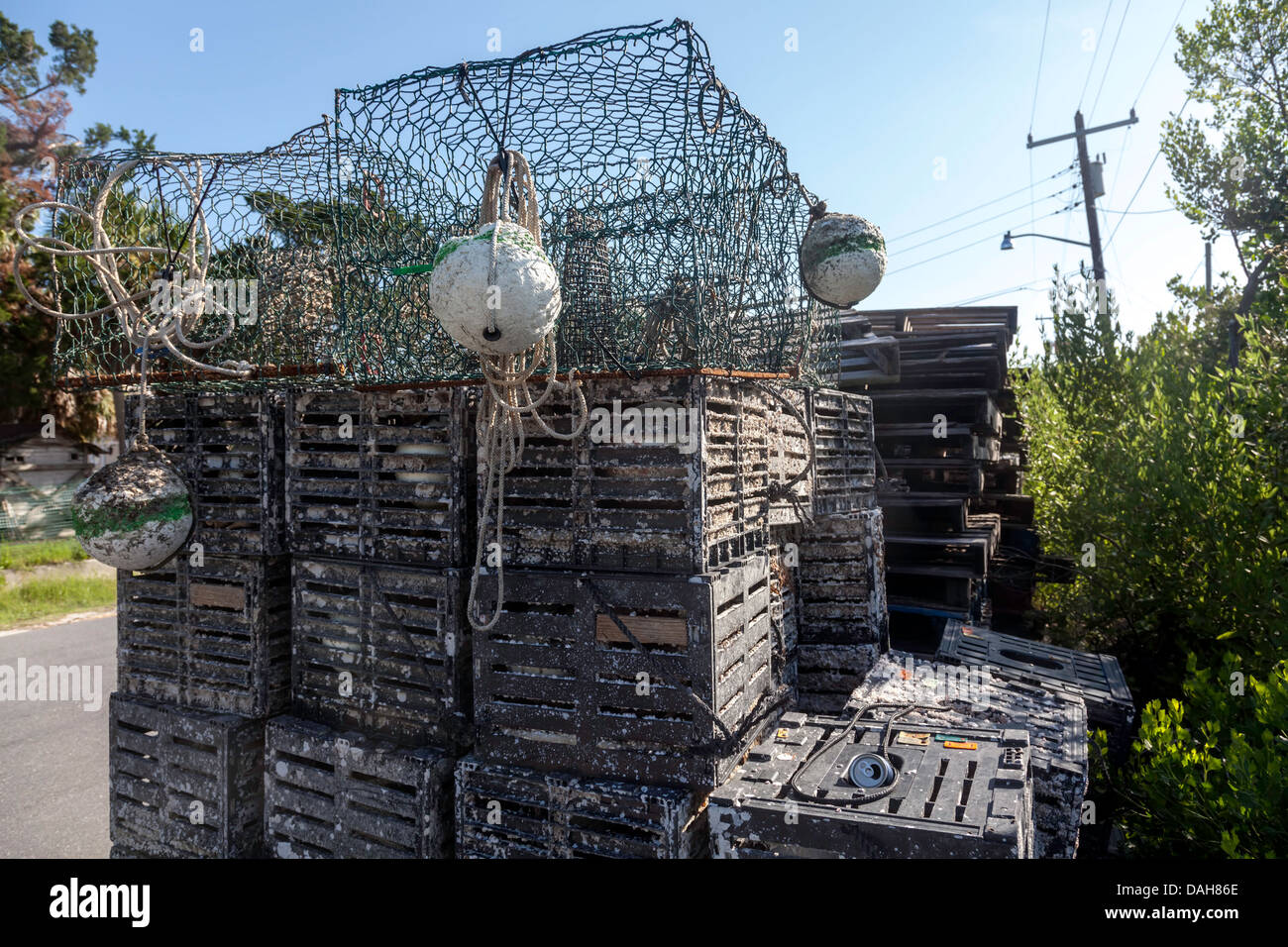 Commercial seafood shellfish traps and floats stacked by the roadside ...