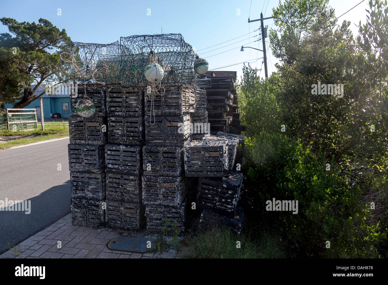 Commercial seafood shellfish traps and floats stacked by the roadside ...