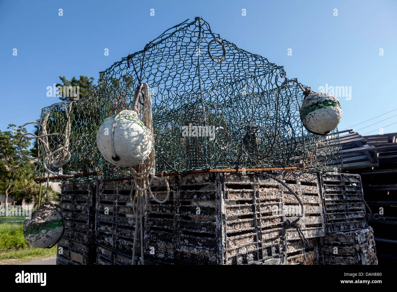 Commercial seafood shellfish traps and floats stacked by the roadside ...