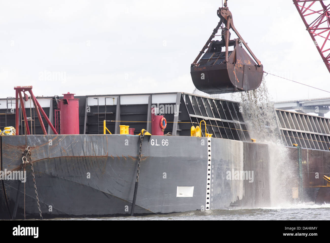 A clamshell dredge excavates the shipping channel in Charleston Harbor ...