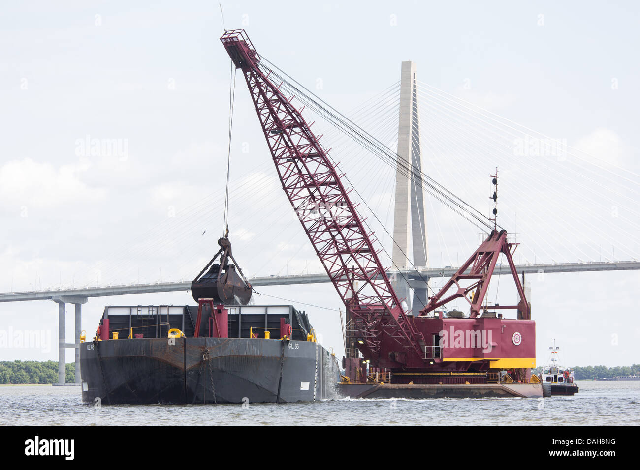 A clamshell dredge excavates the shipping channel in Charleston Harbor ...