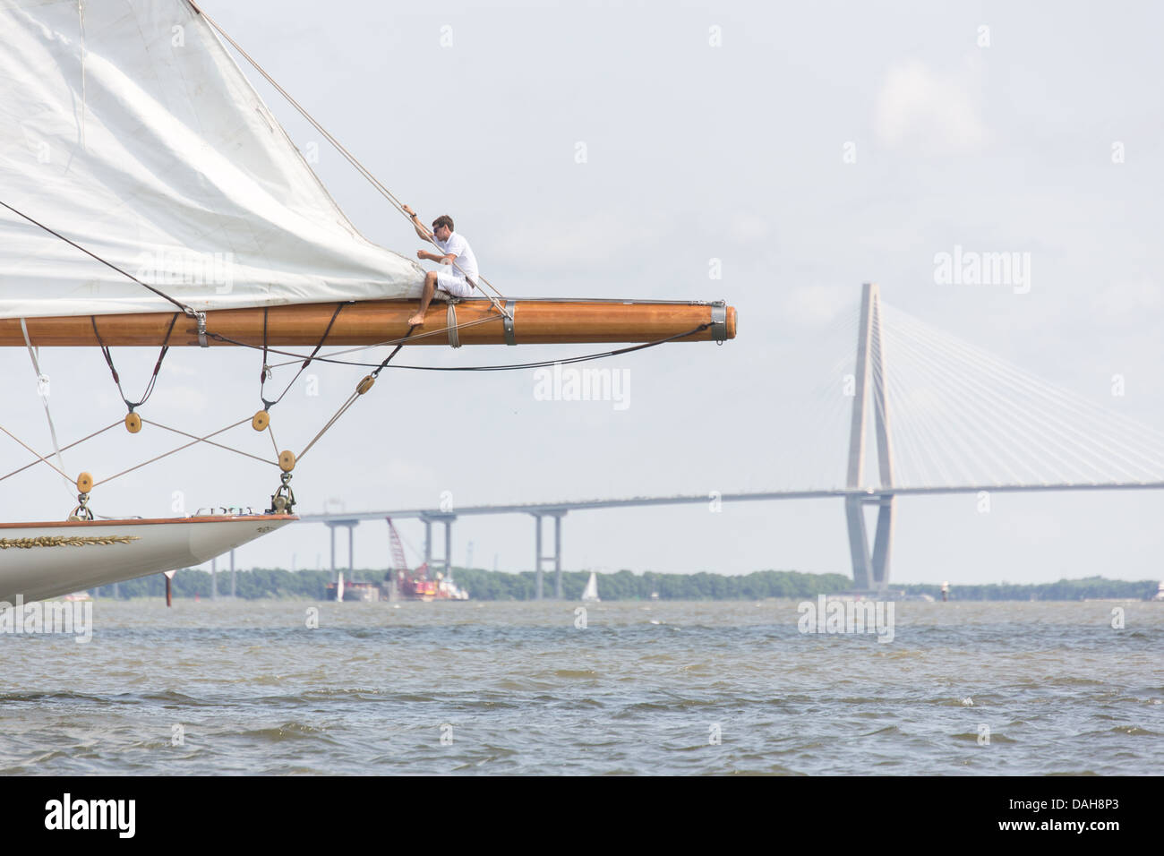 A deck hand rigs the sails on the 196-foot sailing yacht Germania Nova ...