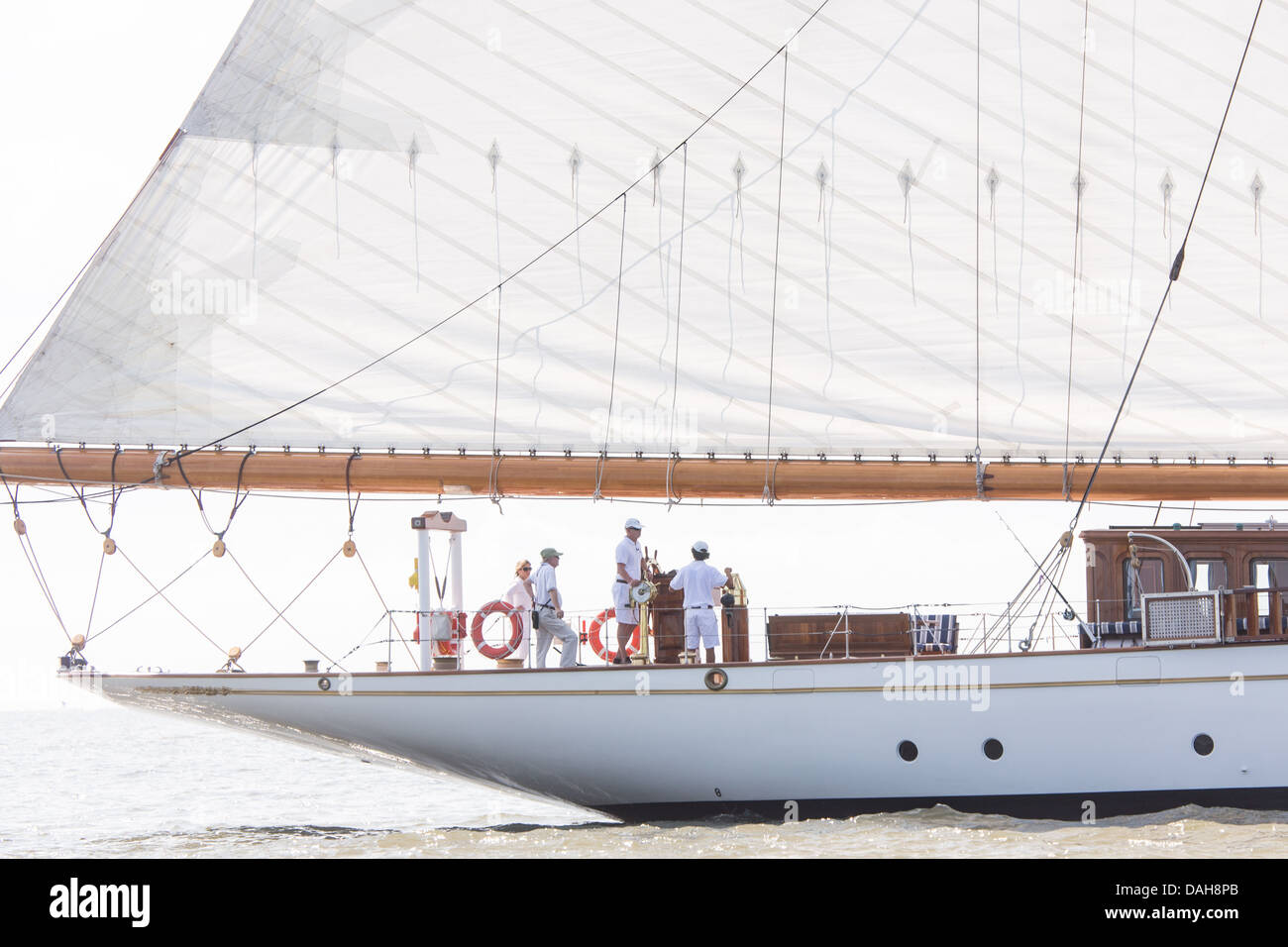 The crew steers the 196-foot sailing yacht Germania Nova as it sails ...