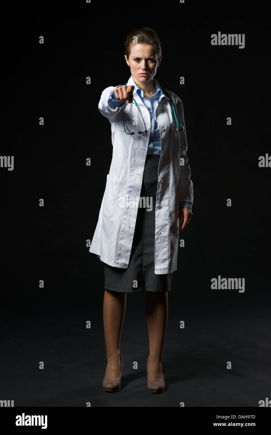 Full length portrait of serious doctor woman pointing in camera ...