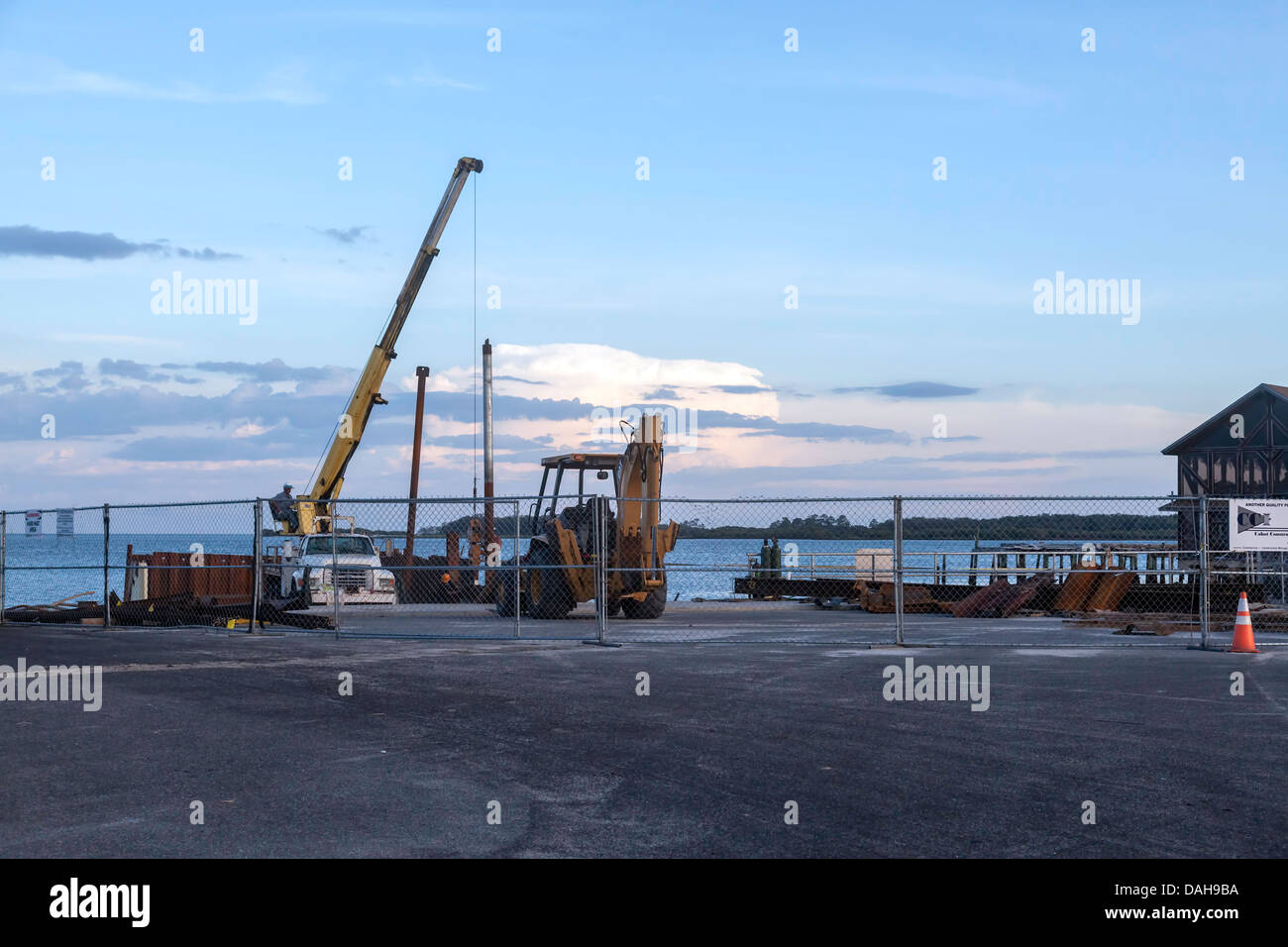 Vehicle mounted mobile crane and backhoe are visible inside a chain ...