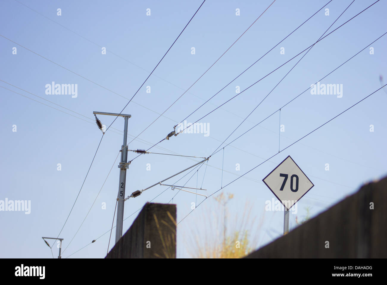 Train railroad electric cables and sign Stock Photo - Alamy