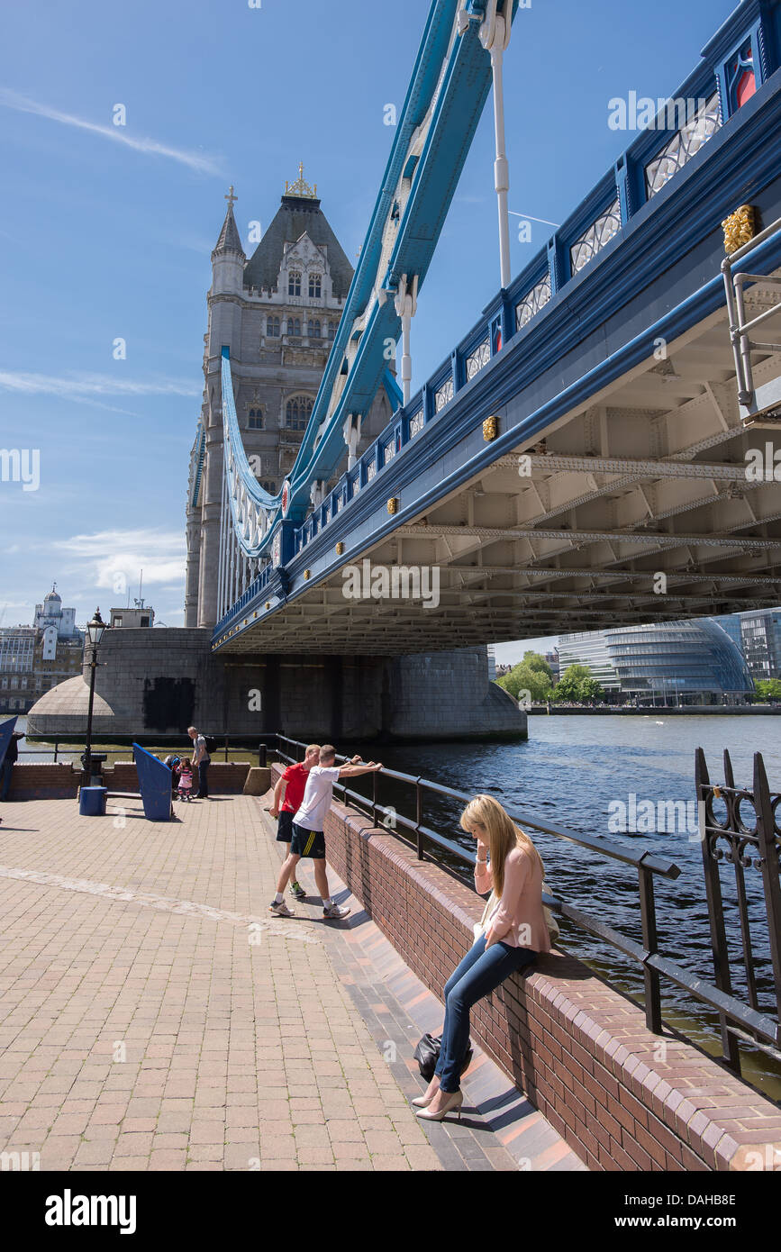 Sitting in the sun under Tower Bridge Stock Photo - Alamy