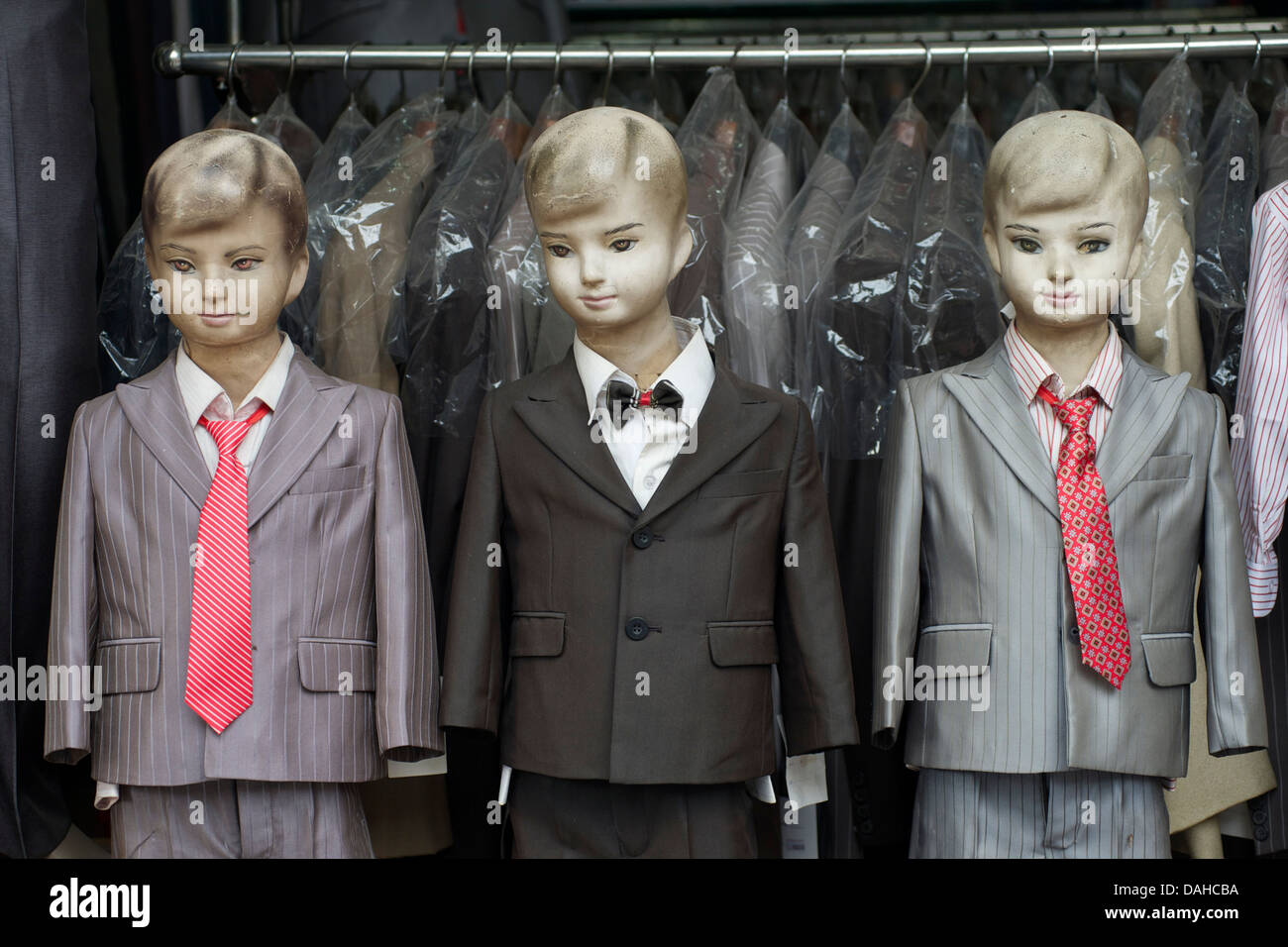Three boys mannequins wearing formal suits. Tailor Stock Photo - Alamy