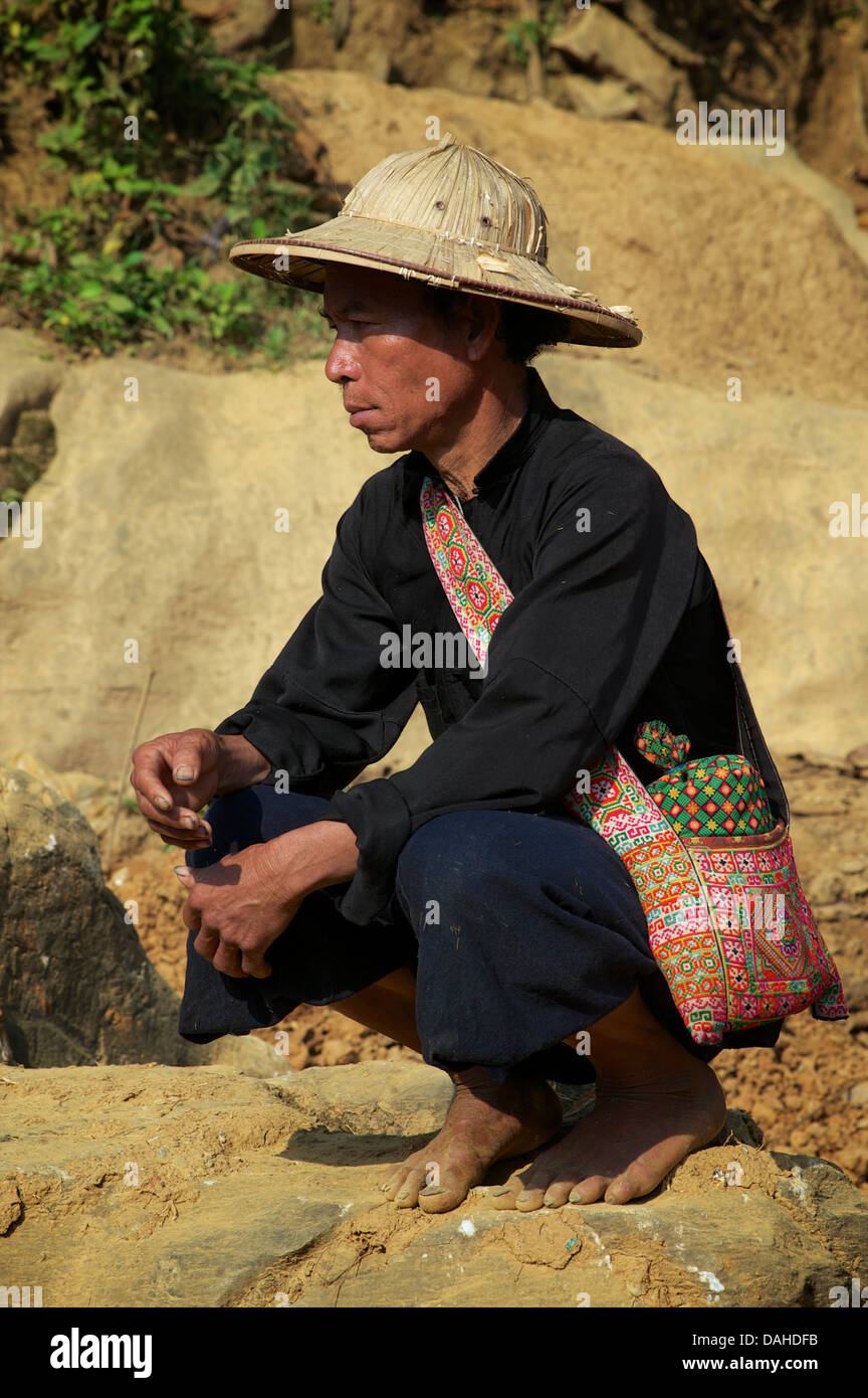 Hmong man in distinctive attire and embroidered hip bag, Can Cau, near ...