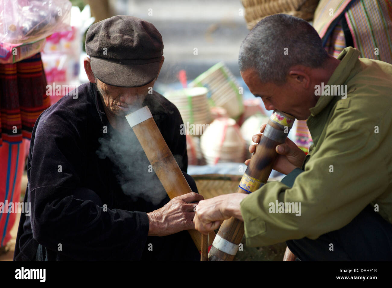 Smoking tobaco in a water-filled bamboo bong. Can Cau market, near Bac ...