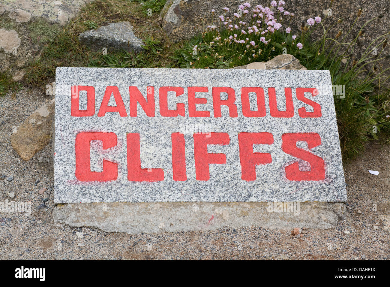 A Stone sign painted on the cliffs at Lands End "Dangerous Cliffs ...