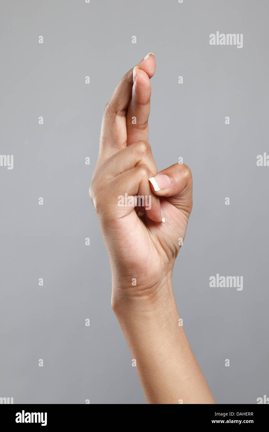 Woman's hand with crossed fingers Stock Photo - Alamy