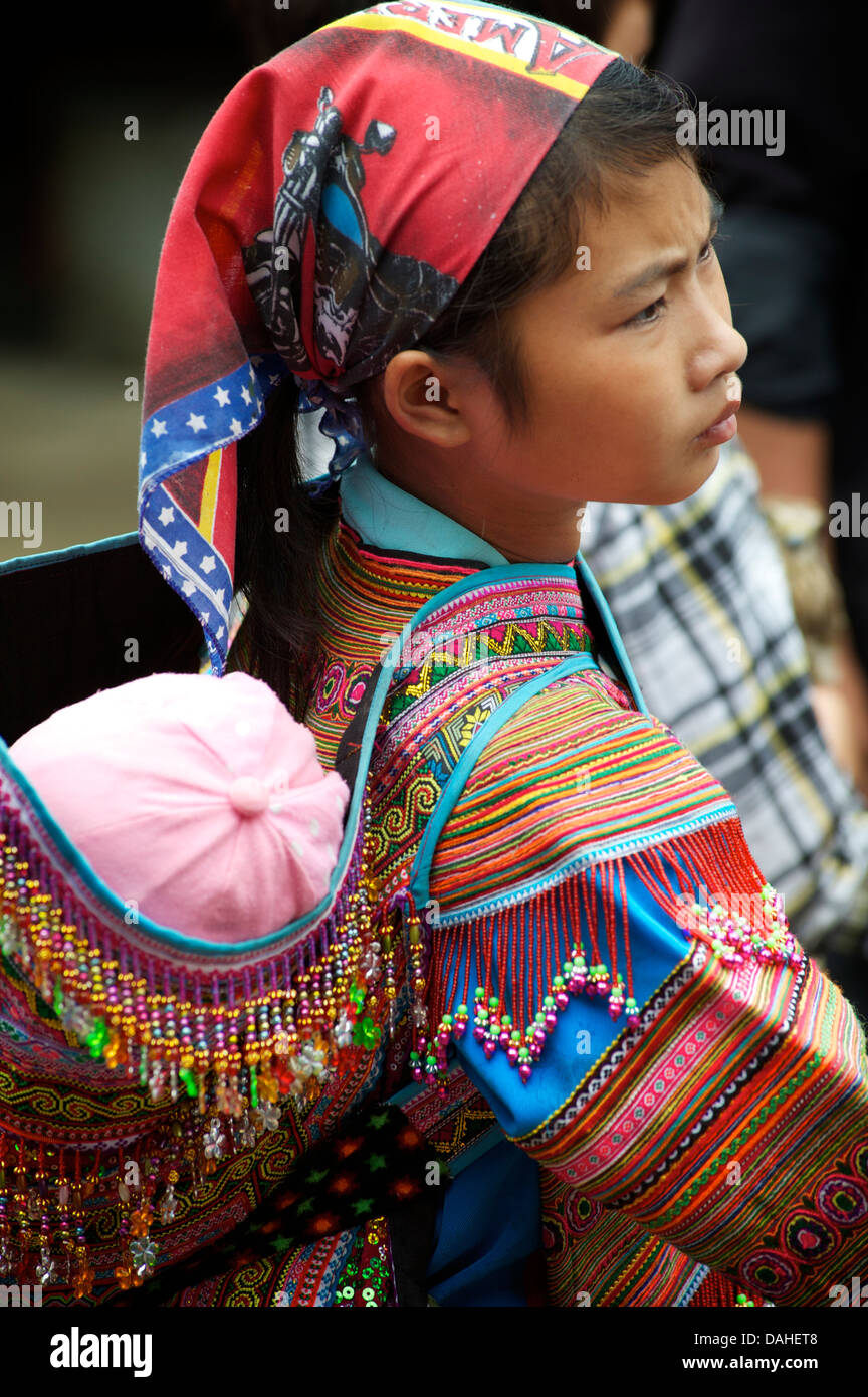 Flower Hmong girl carrying baby on her back, Bac Ha market, Lao Cai ...